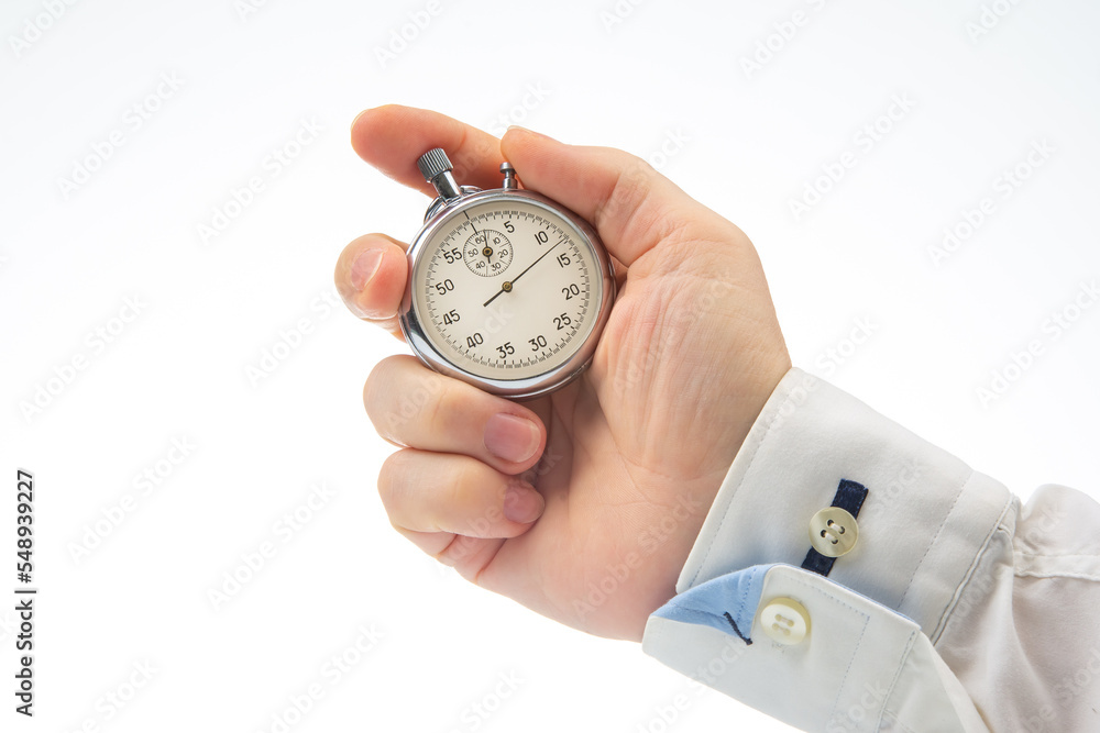 hand with a mechanical analog stopwatch on a white background. Time ...