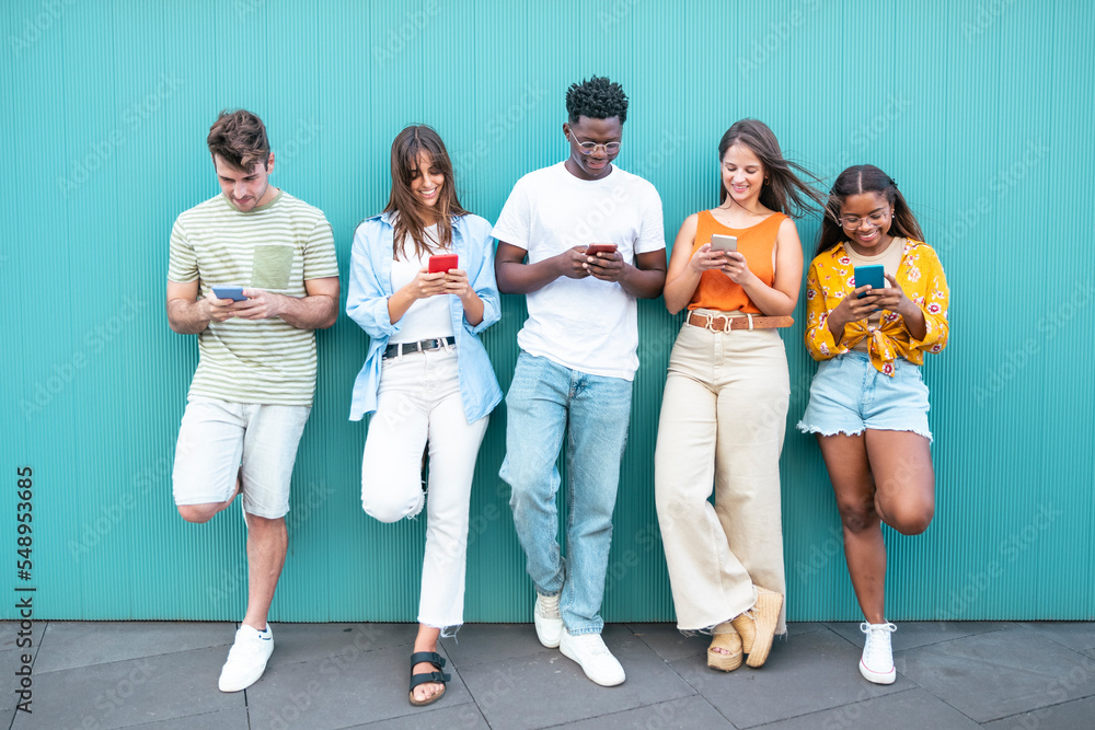 Group multiracial friends using smartphones outside. Group of fashion ...