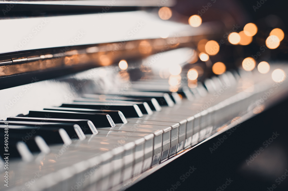 Piano keys over glow Christmas lights close up. Romantic lifestyle ...