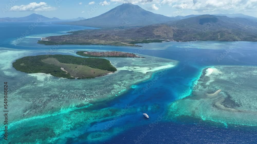 Coral reefs and seagrass meadows fringe small islands just west of ...