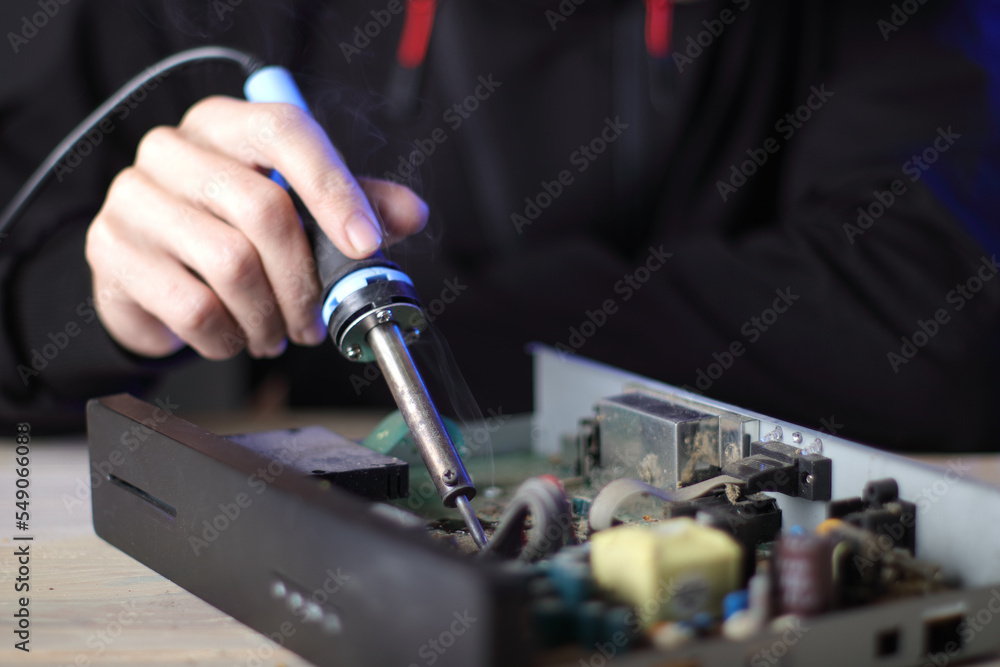 repair of an old satellite tuner by a person on a table Stock Photo ...