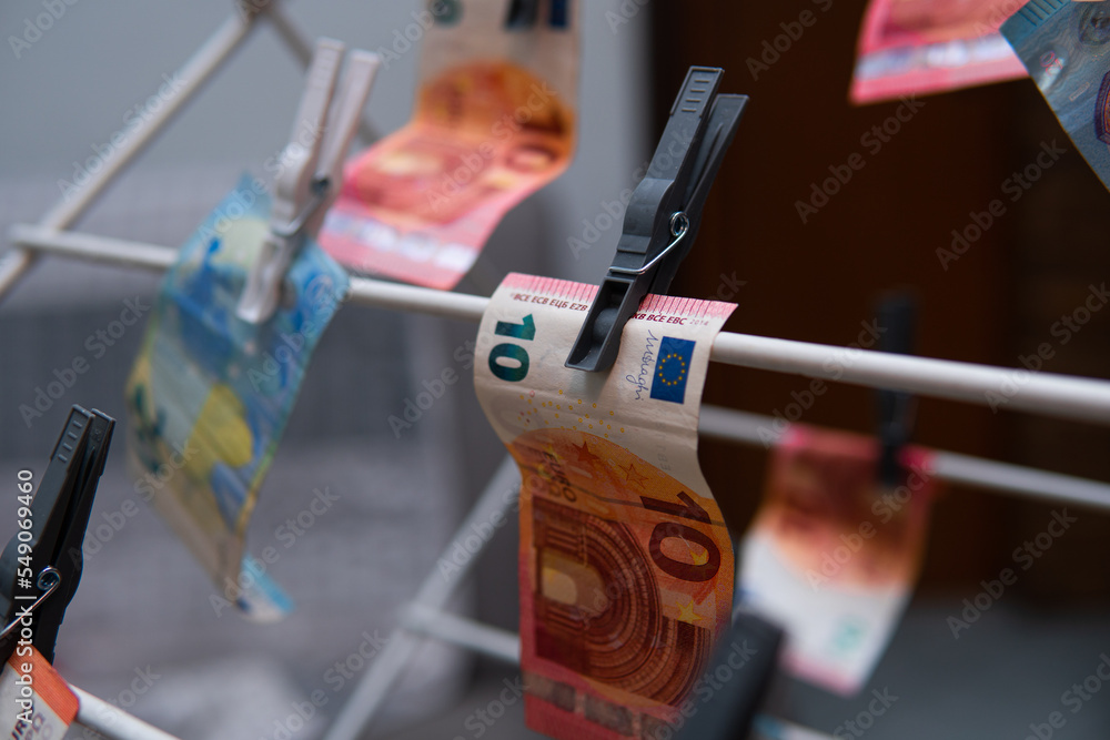 Euro banknotes on a drying line. Concept showing money laundering and ...