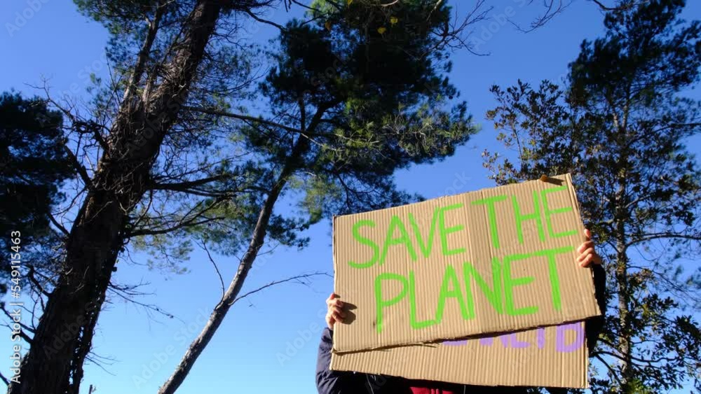 Child With a cardboard sign claiming the protection of the earth ...