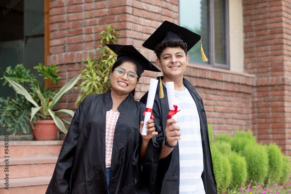 Happy young indian graduated students holding his graduation degree convocation ceremony. Stock ...