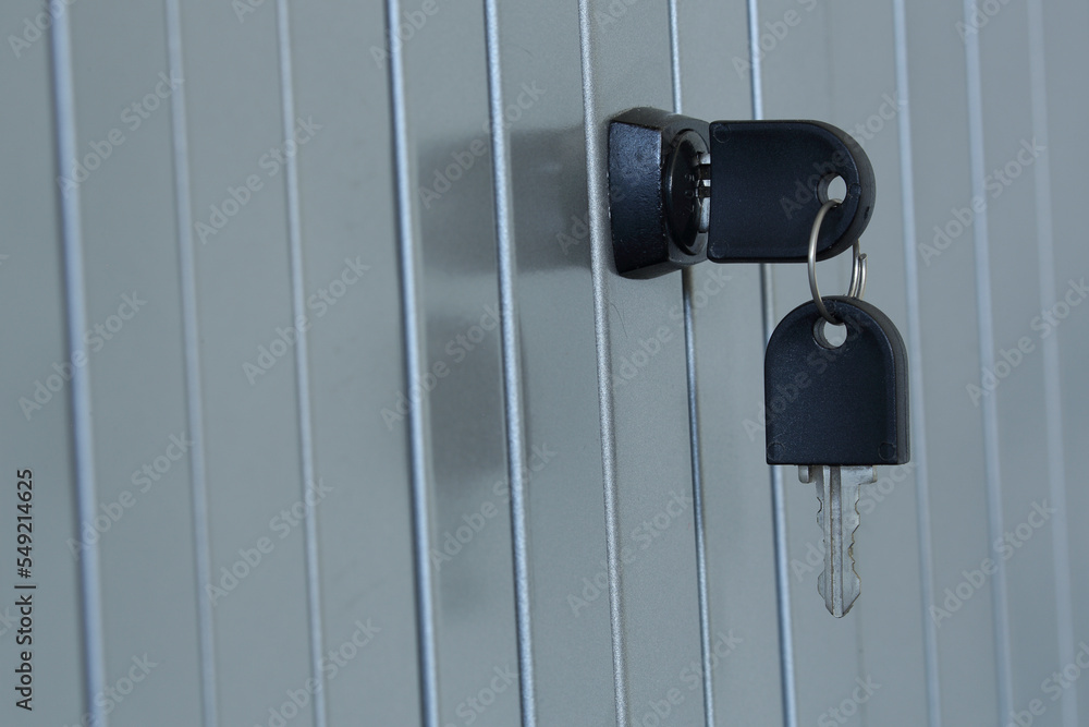 Keys in the lock of an office cubicle. Stock Photo | Adobe Stock
