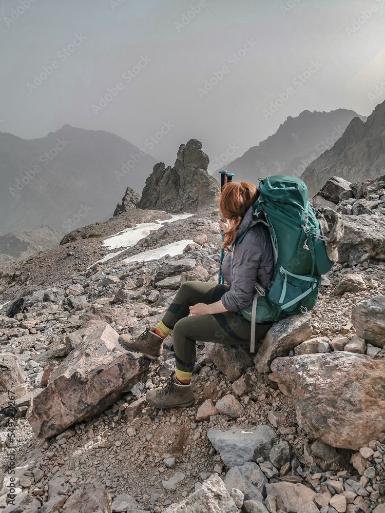 Woman hiking the long distance hike in Corsica called the GR20. A long ...
