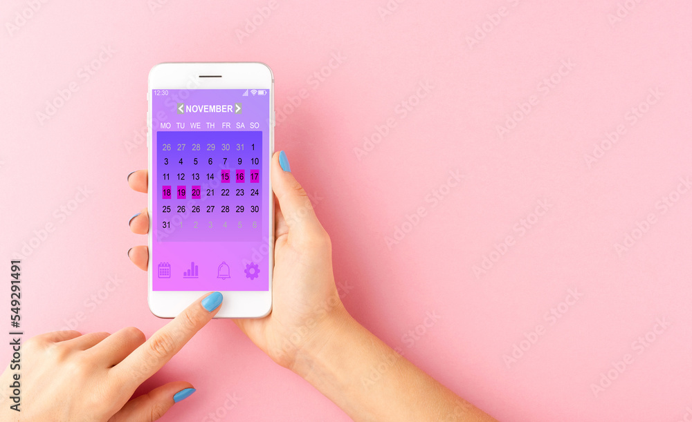 Menstrual cycle tracker mobile app on smartphone screen in woman's ...