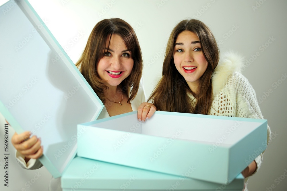 Mom and daughter look into Pale blue big boxes are surprised have fun ...