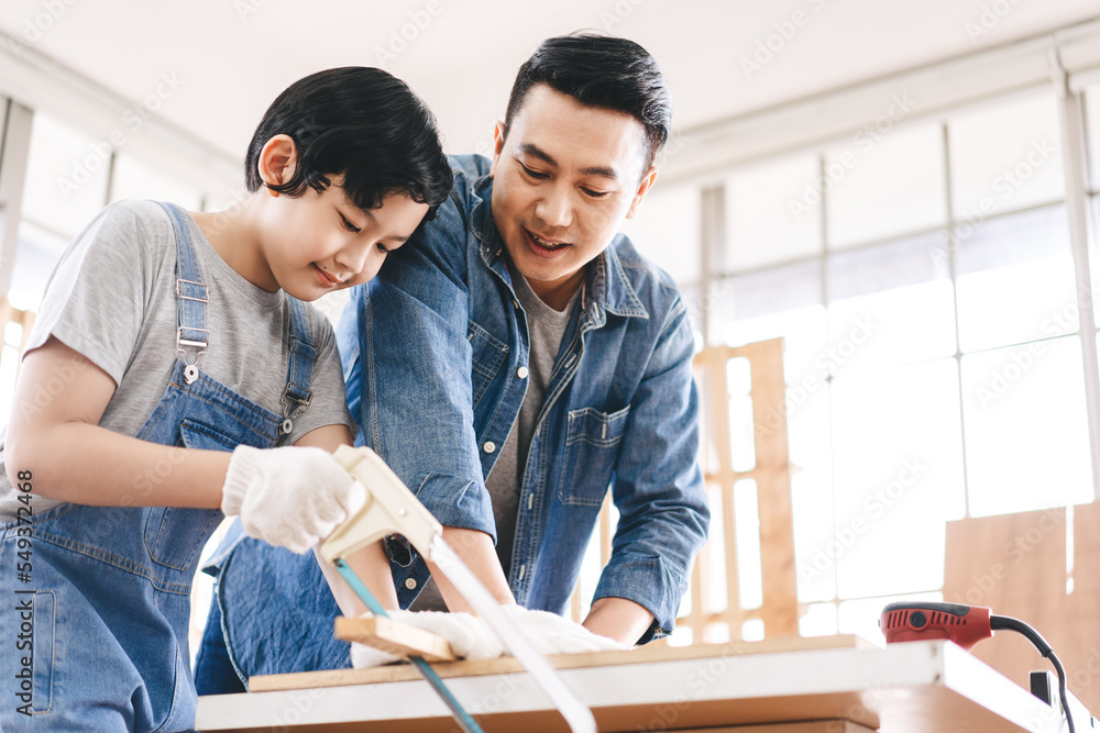 Southeast asian family father and son diy or repair for crafts skill at ...