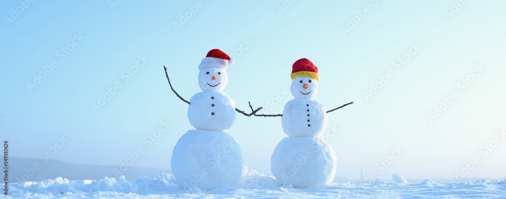 Couple of two snowman holding hands outdoors. Snowman on the snow ...
