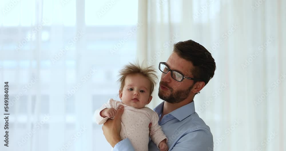 Vidéo Stock Happy handsome young dad cuddling cute little baby, lifting ...