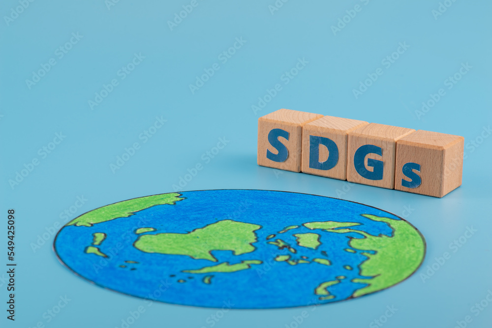 SDGs - sustainable development goals word concept on cubes,and hand ...