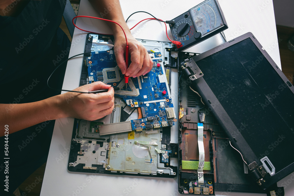 computer technician Laptop Motherboard Repairman Using IC Meter To Find ...