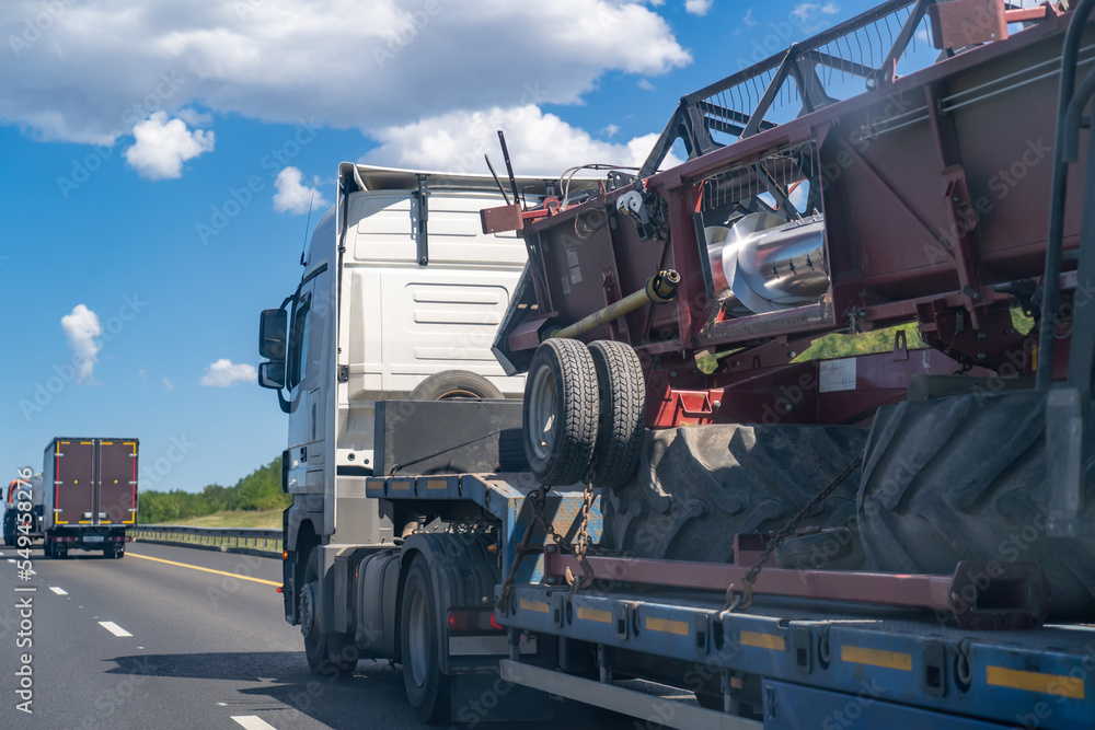 Heavy industrial truck with low side on low-frame platform transports ...