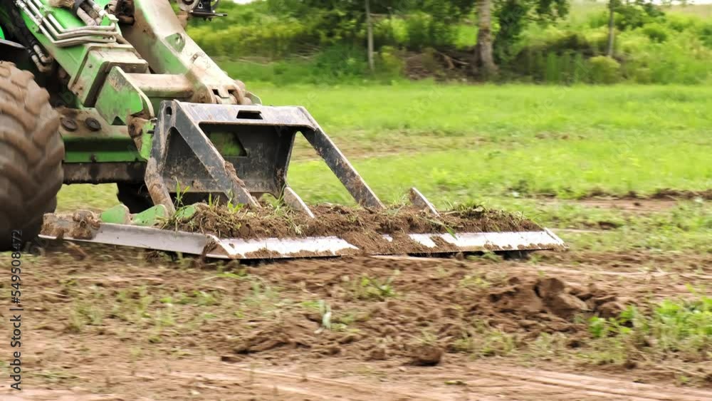 Land work by the territory improvement. Small tractor with a ground ...