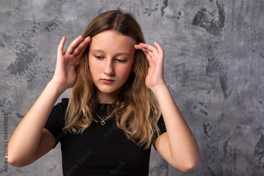 Face sorrowful sad teen girl in black clothes thinking looking down, at ...