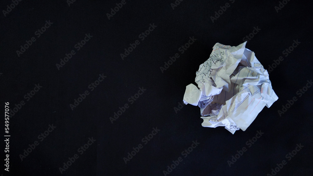 Paper waste isolated on black background. A piece of crumpled white ...