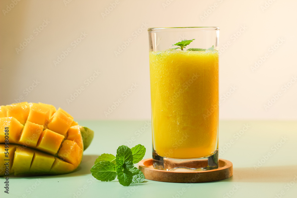 Fresh Mango Juice. Served with a natural green background color along ...