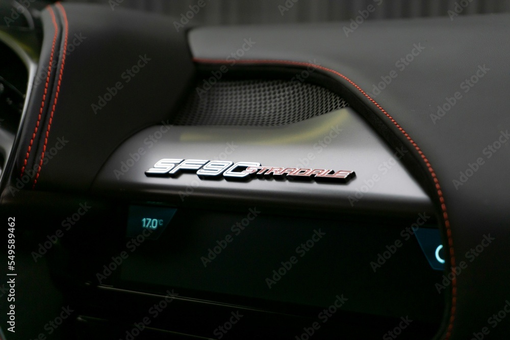 Closeup of a Ferrari SF90 Stradale badge on a dashboard in black ...