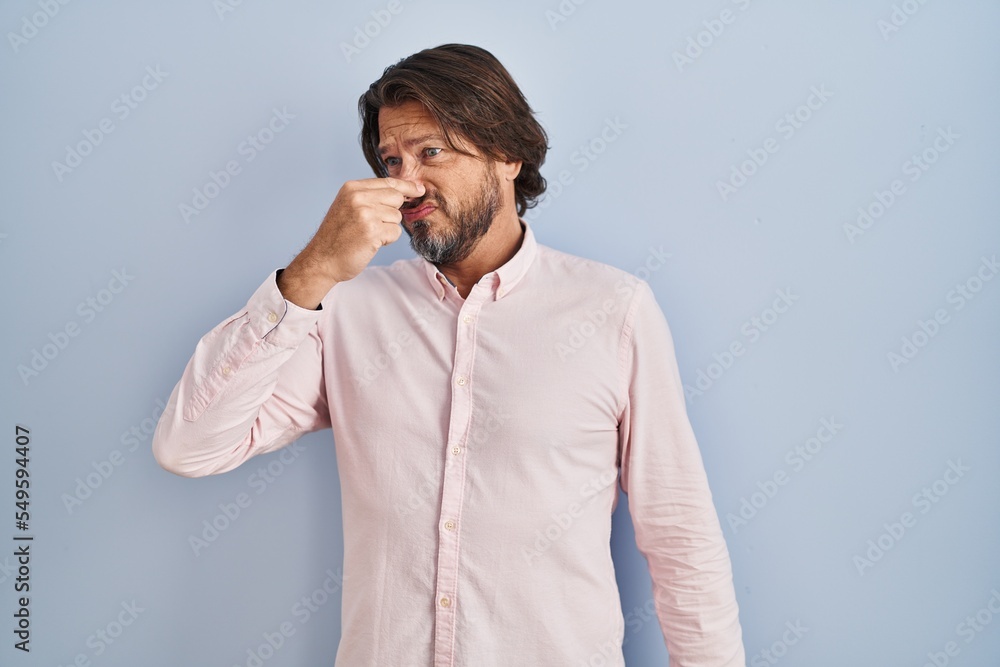 Handsome middle age man wearing elegant shirt background smelling ...