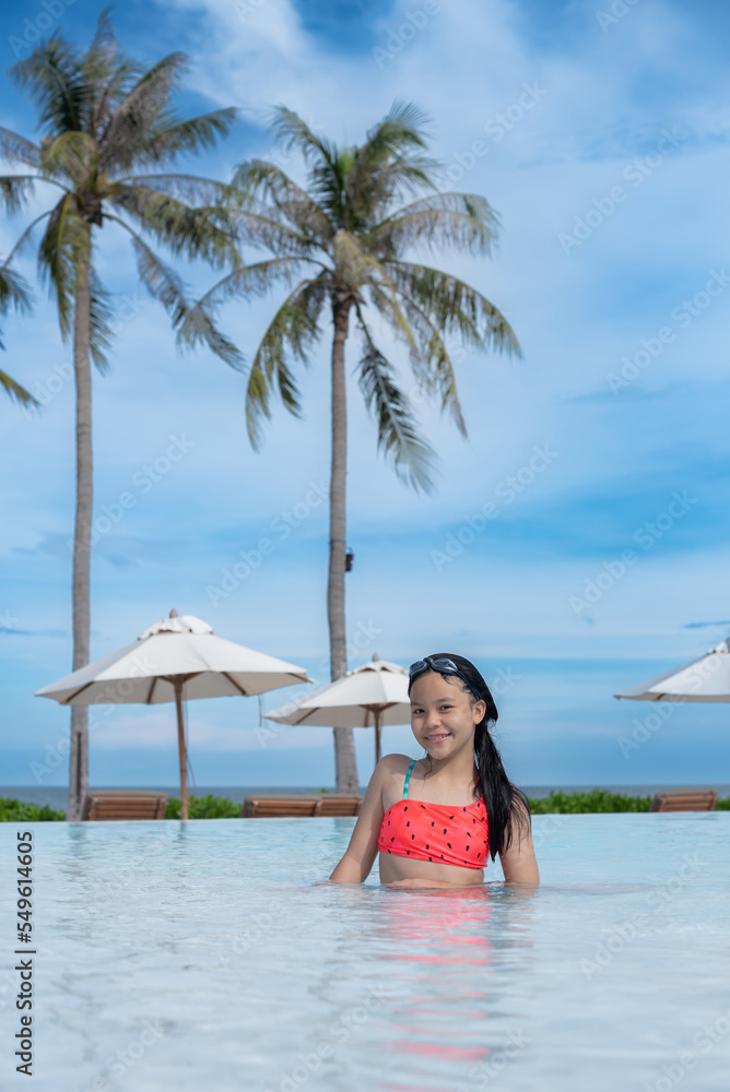Happy girl enjoying summer vacations in a pool. Summer holidays ...