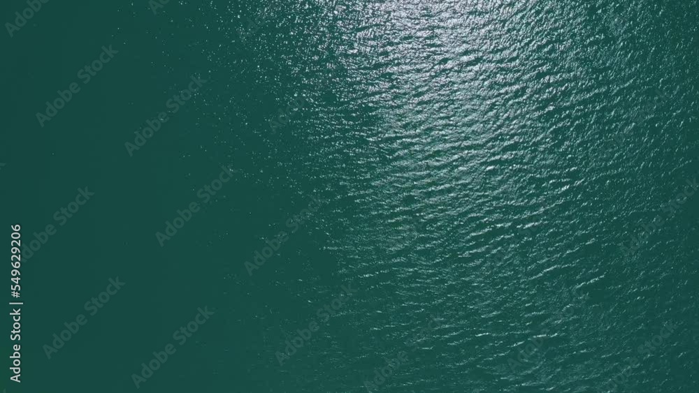 A top down view of a large body of water, with ripples and waves ...