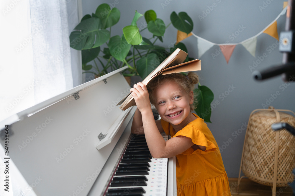 Cute smiling girl with musical notes at piano at home Stock Photo ...