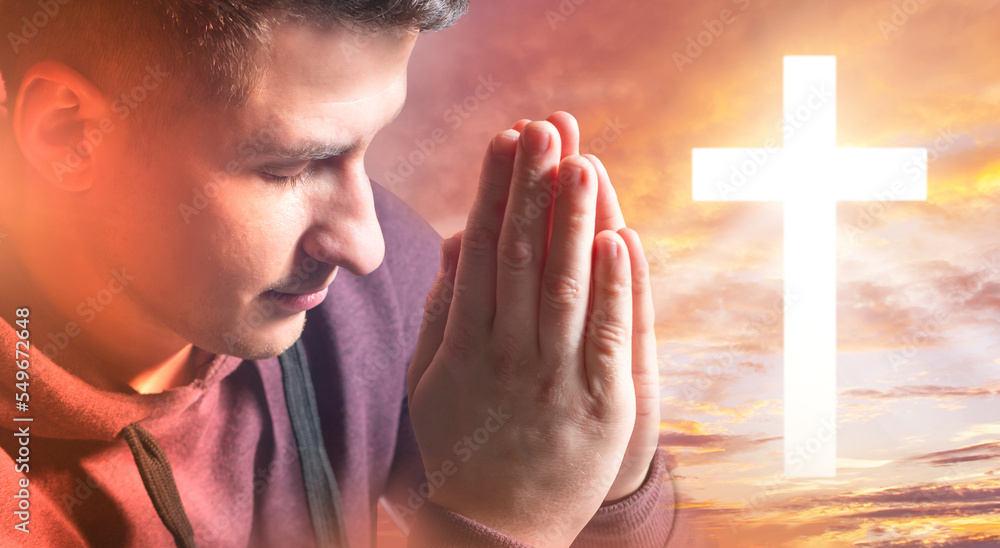 Man prays to God. Christian makes gesture of praying. Catholic cross ...