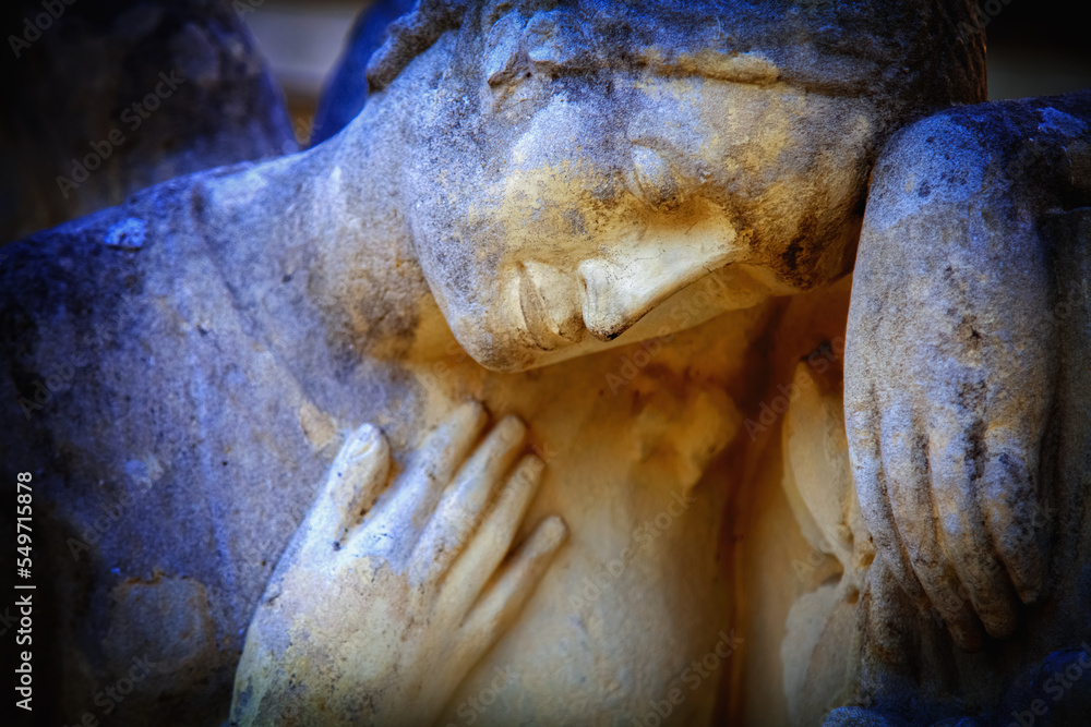 Fragment of an ancient stone statue of sad and desperate woman on tomb ...