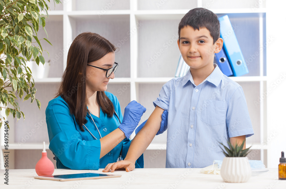 vaccination of children, a little boy at a doctor's appointment, an ...