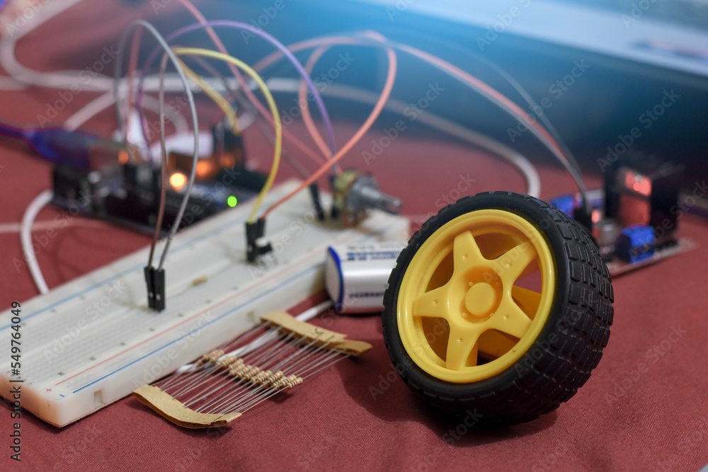 Robotic wheel, register, breadboard, battery, motor driver, jumper wire ...