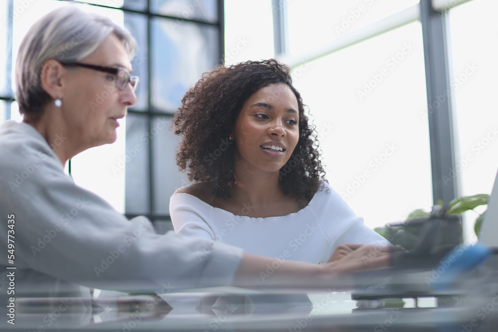 Female colleagues of different nationalities and ages met in the office ...