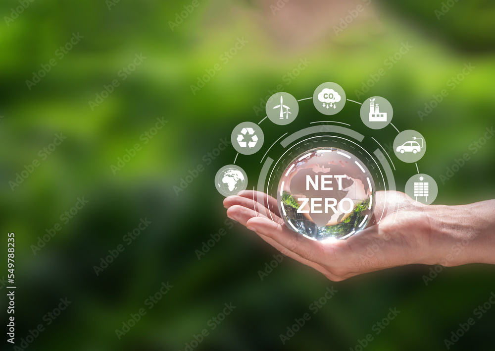 Net zero icon and carbon neutral concept in the hand for net zero greenhouse gas emissions ...