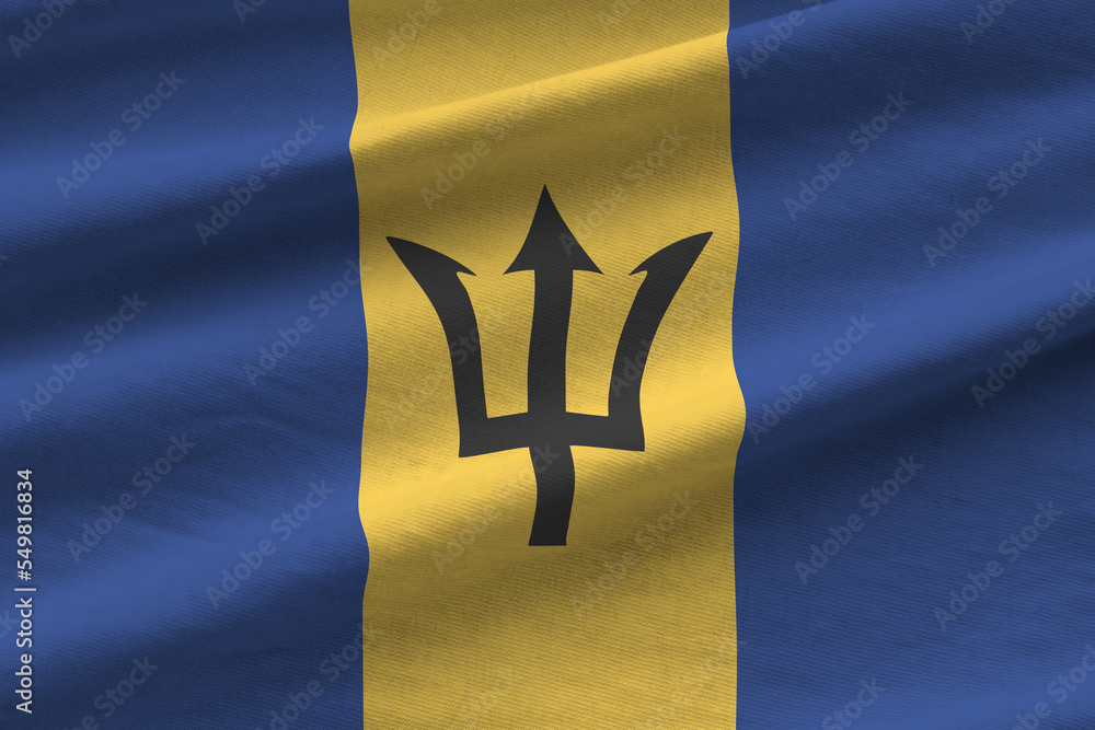Barbados flag with big folds waving close up under the studio light ...