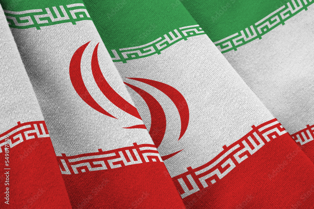 Iran flag with big folds waving close up under the studio light indoors ...