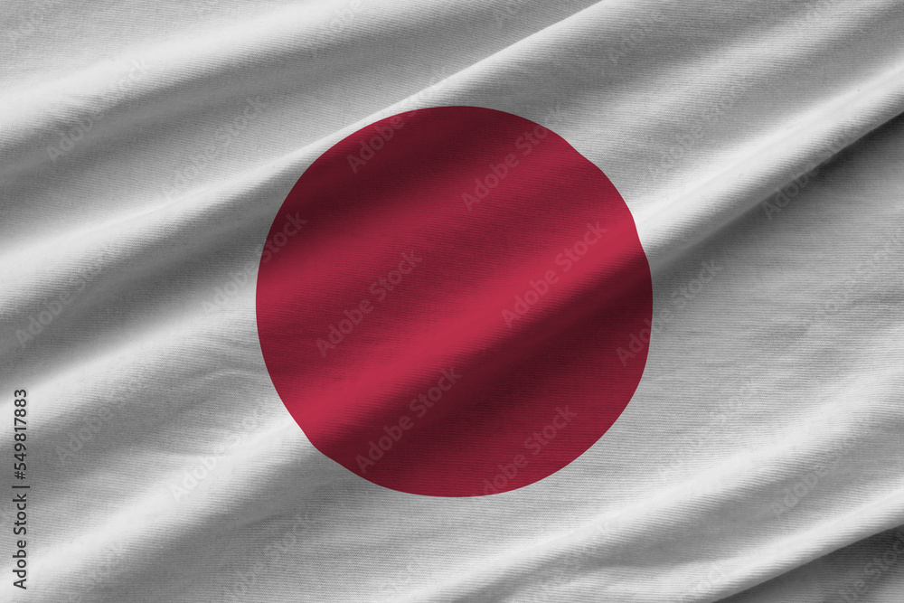 Japan flag with big folds waving close up under the studio light ...