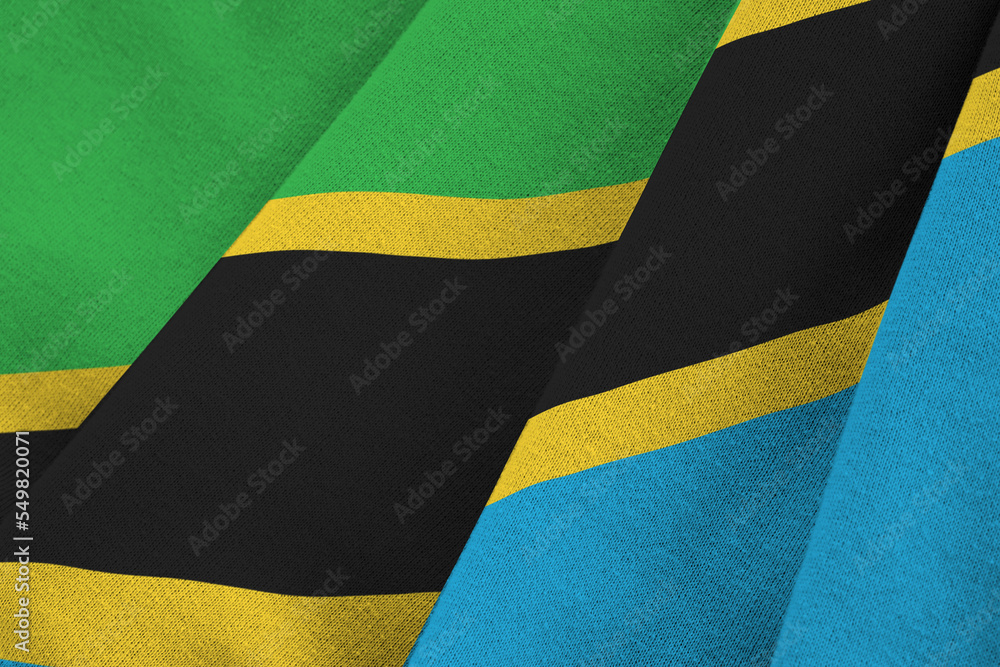 Tanzania flag with big folds waving close up under the studio light ...