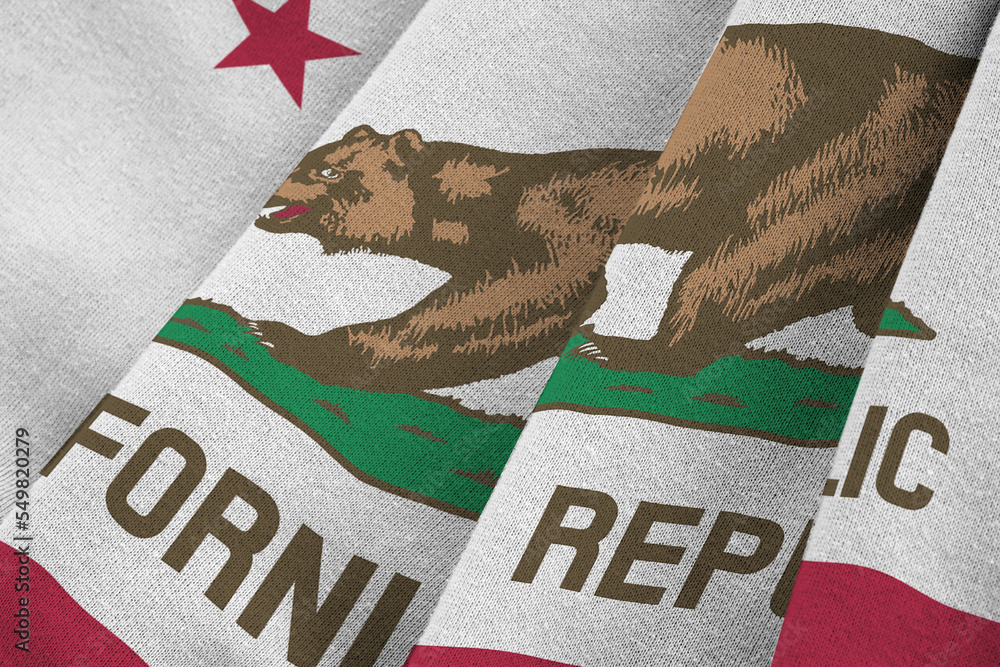 California US state flag with big folds waving close up under the ...