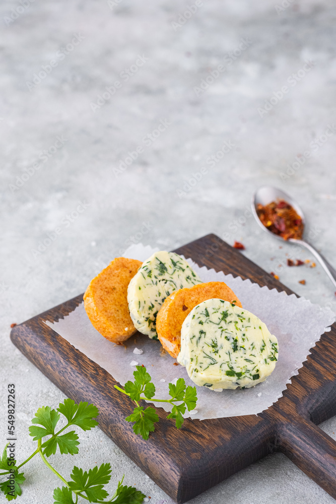 Assorted, salted butter with parsley and butter with paprika and salt ...