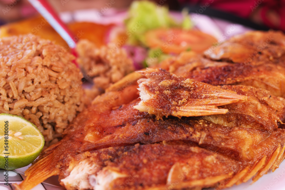 delicious fried mojarra with coconut rice, salad and patacones on the ...