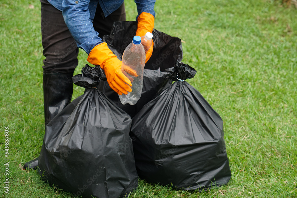 Closeup garbage collector worker hands hold plastic bottles to put into ...