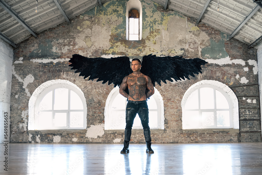 angel man with black wings, stand posing at camera. man fall from ...