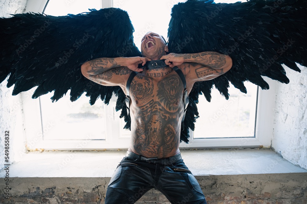 angel man with black wings, stand posing at camera. man fall from ...