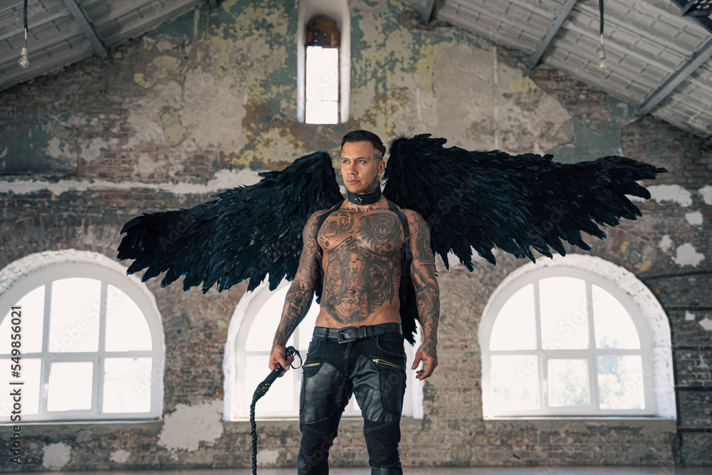 handsome man with wings.Male angel with black wings. Muscular shirtless ...
