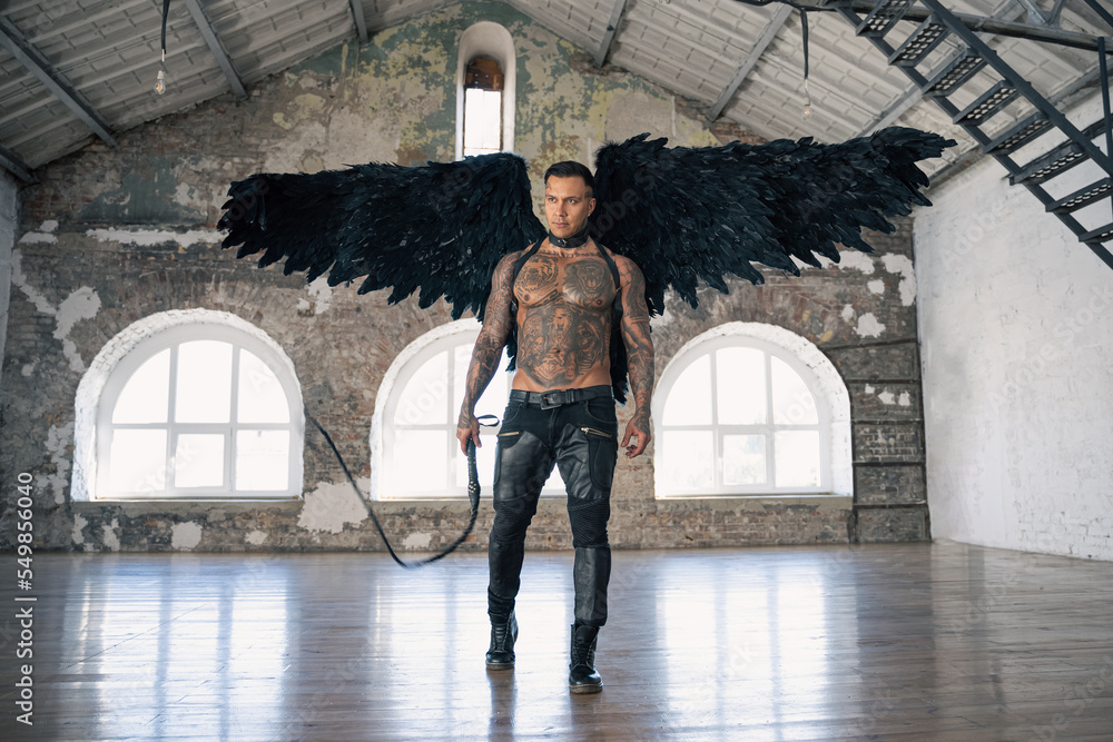 handsome man with wings.Male angel with black wings. Muscular shirtless ...