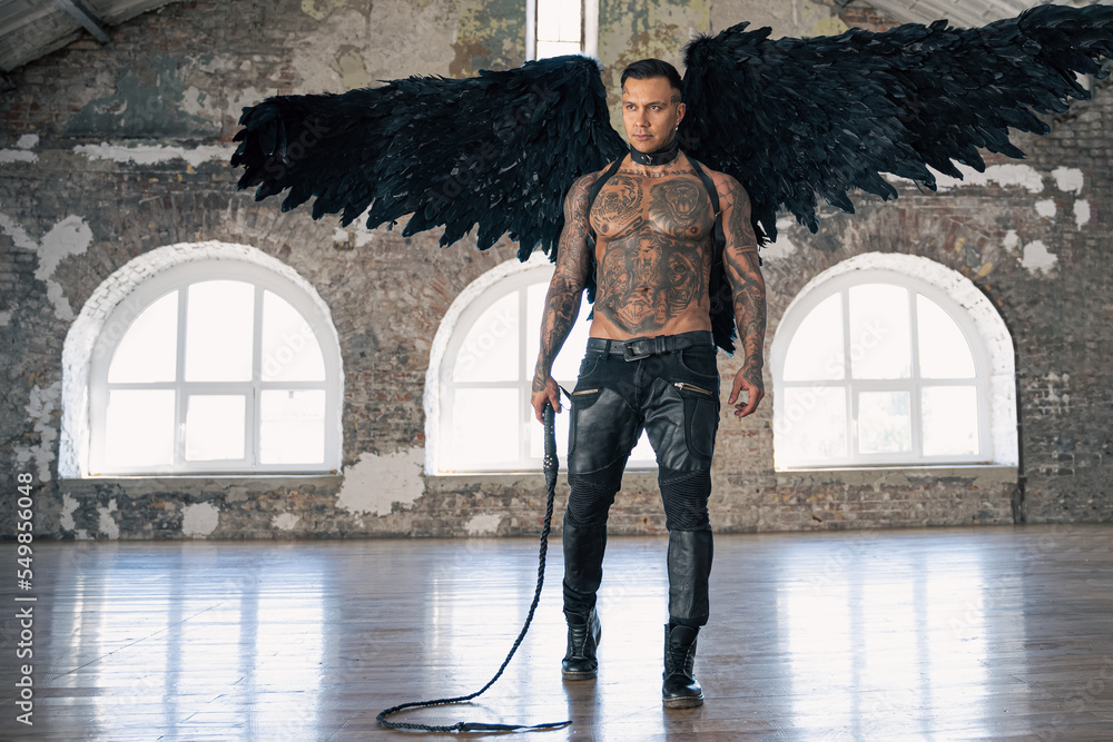 handsome man with wings.Male angel with black wings. Muscular shirtless ...