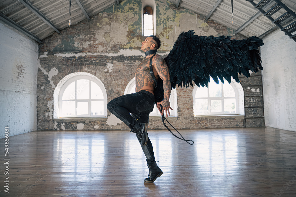 handsome man with wings.Male angel with black wings. Muscular shirtless ...