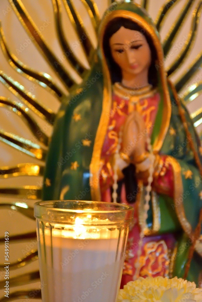 Altar to of Our Lady of Guadalupe with candles, mexican colors and ...