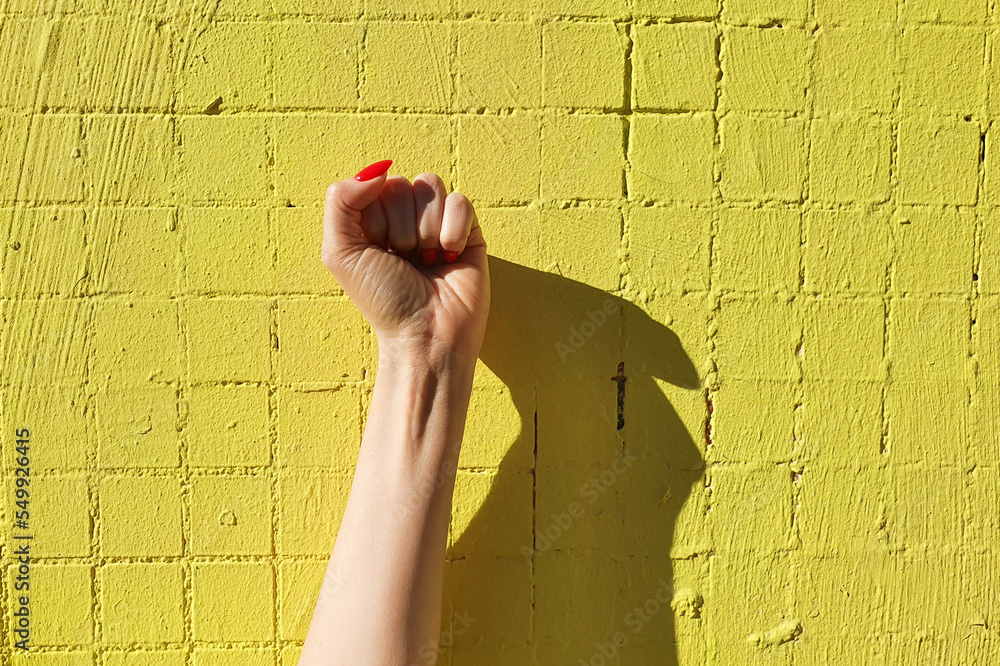 Woman's female fist hand with red nails, fist punch air with shadow on ...