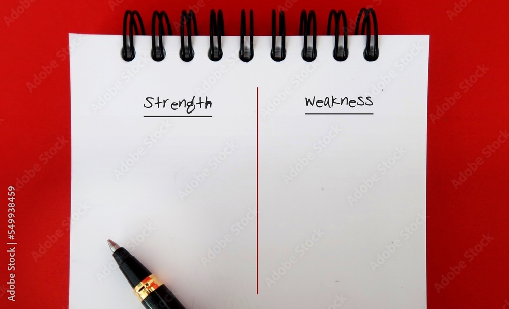 Pen on note book with text written STRENGTH and WEAKNESS - concept of ...